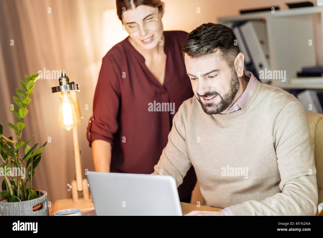 Handsome male person looking at his laptop Stock Photo - Alamy