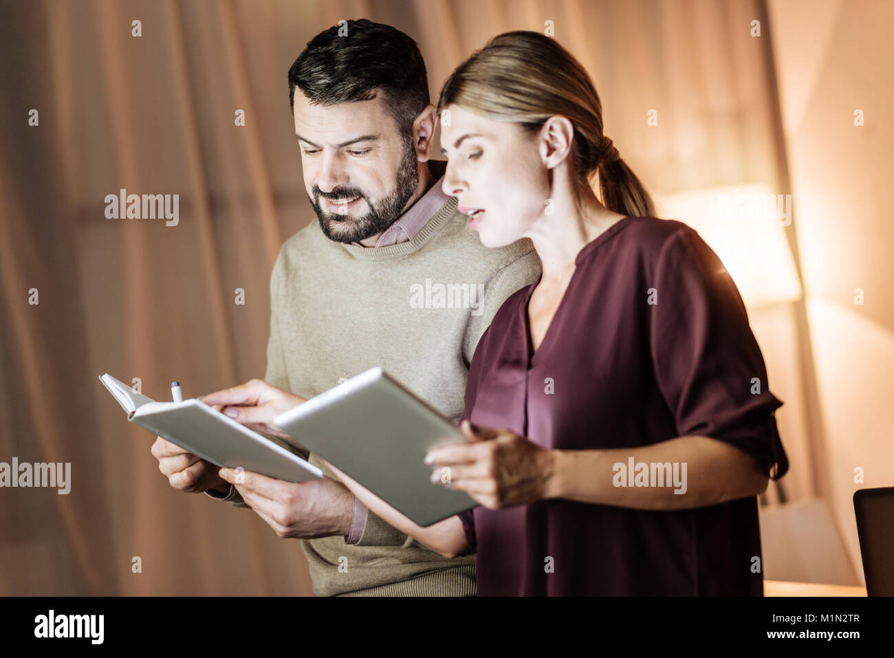 Attentive female person speaking with her colleague Stock Photo - Alamy