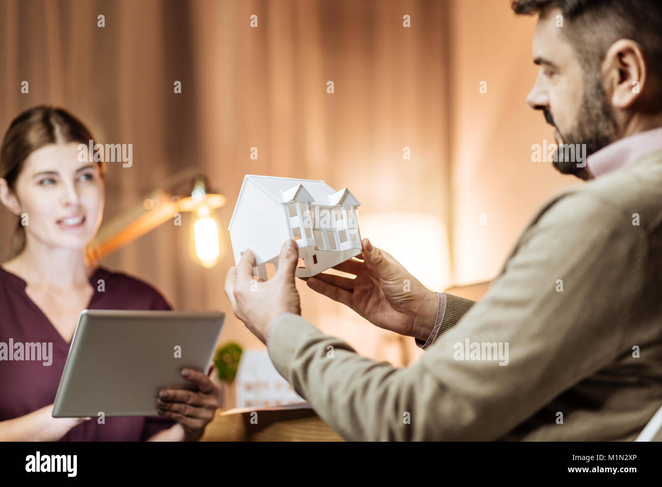 Serious male person comparing results Stock Photo - Alamy