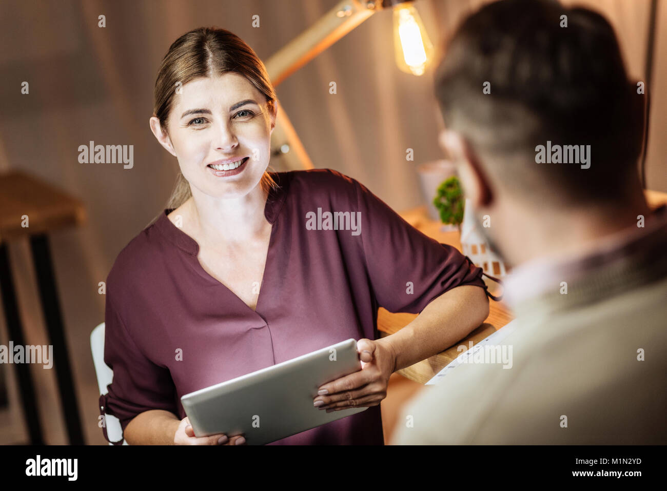 Attractive woman sitting opposite her partner Stock Photo - Alamy