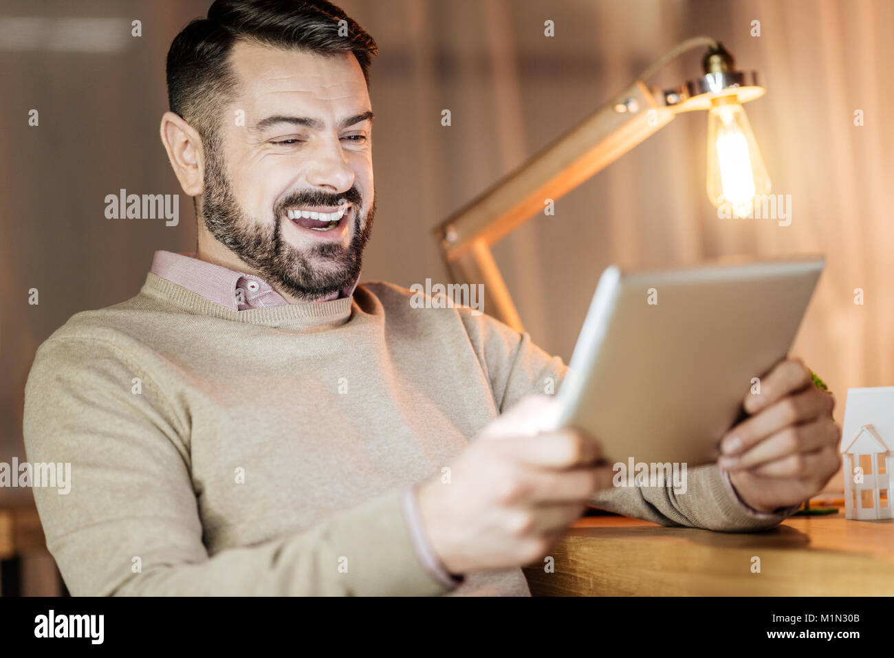 Smiling male person watching video Stock Photo - Alamy