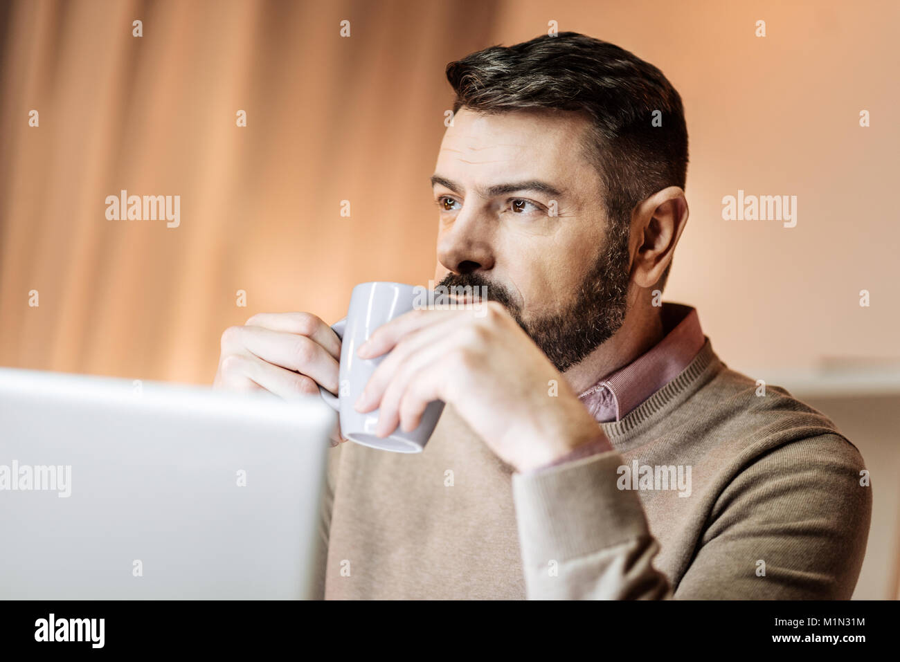 Thoughtful brunette man looking forward Stock Photo - Alamy