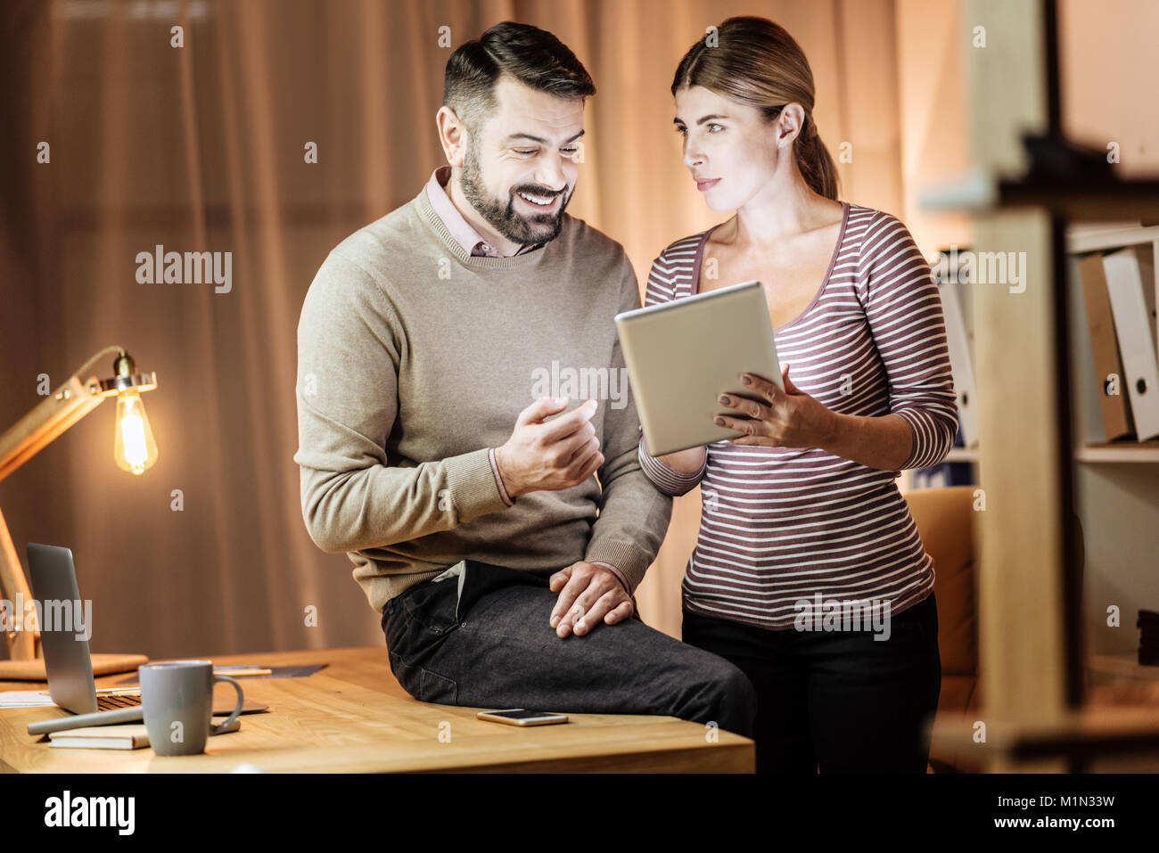 Positive delighted man communicating with his colleague Stock Photo - Alamy