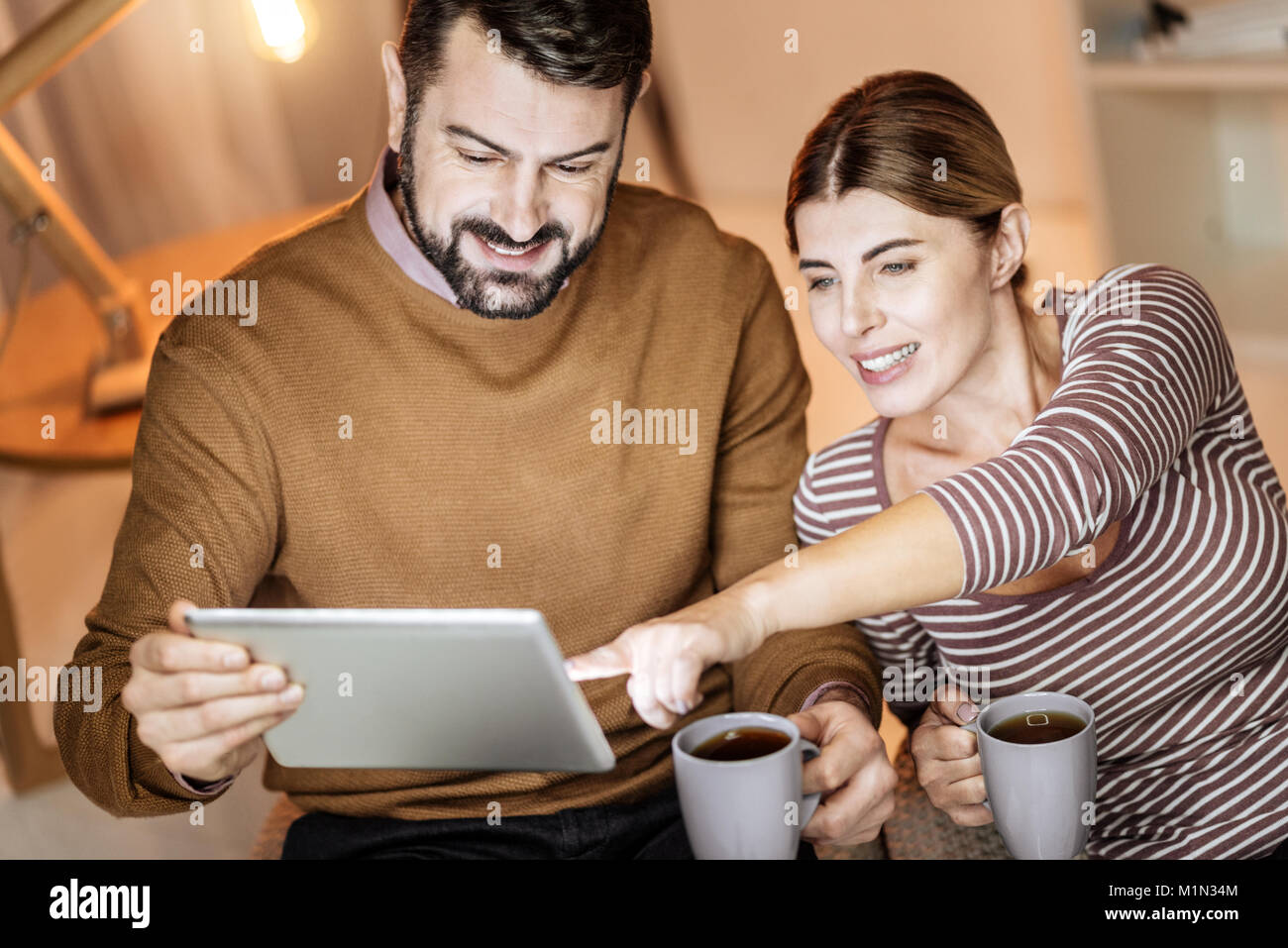 Amazing female pointing at tablet Stock Photo - Alamy