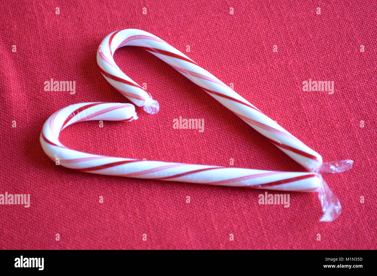 Two candy canes in shape of a heart Stock Photo - Alamy