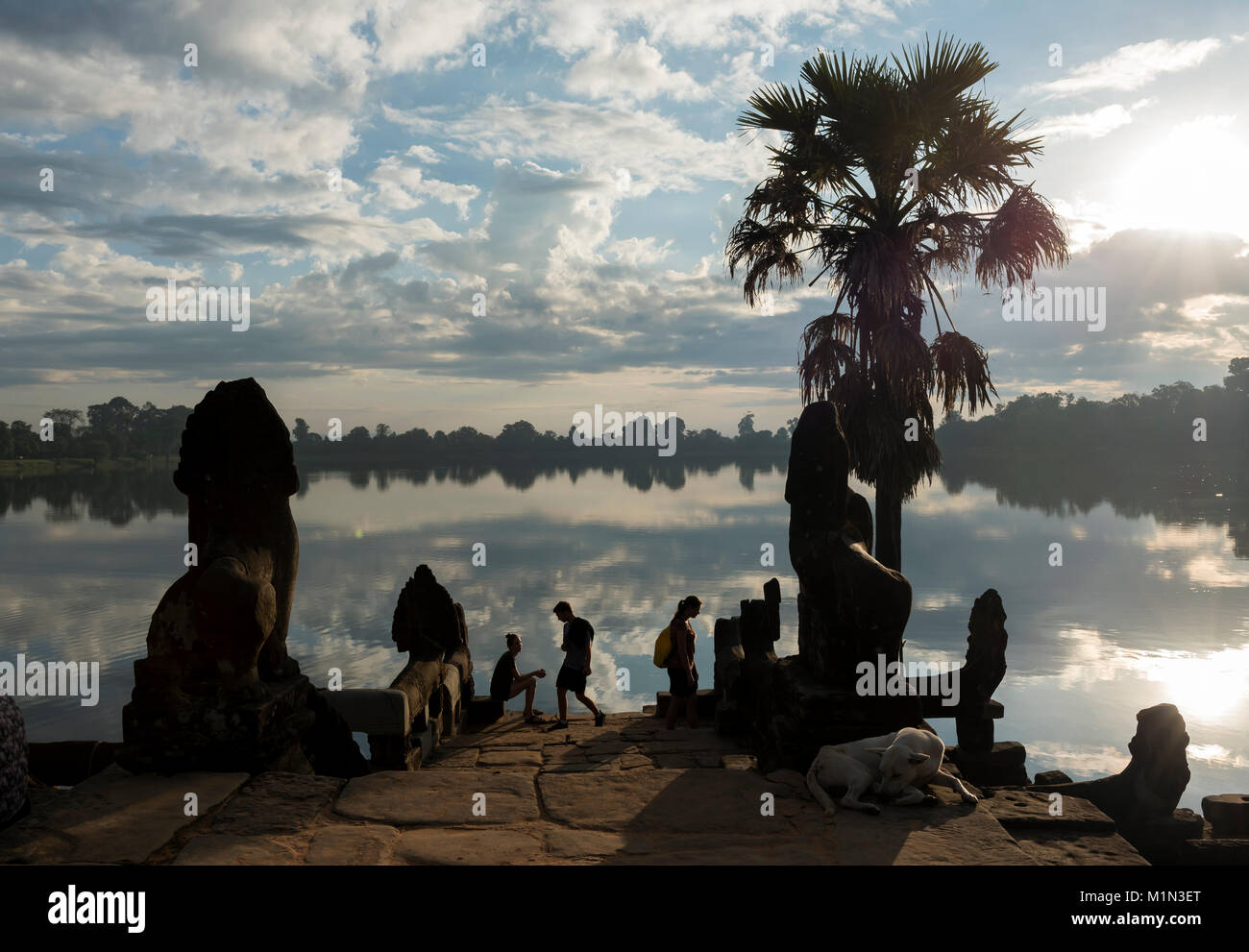 Tourists at sunrise, Srah Srang reservoir, Angkor, Cambodia Stock Photo ...