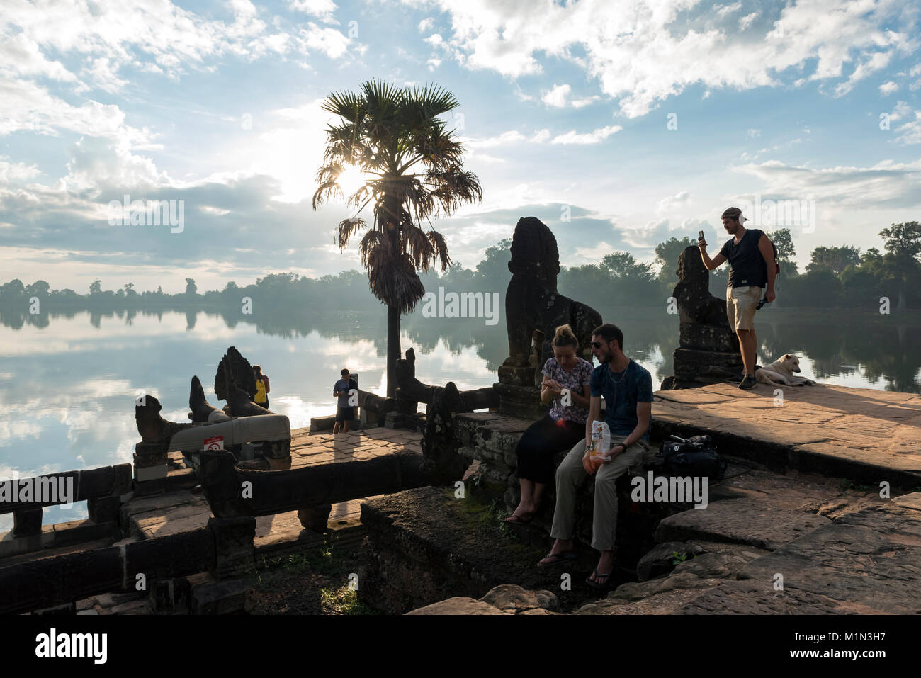 Tourists at sunrise, Srah Srang reservoir, Angkor, Cambodia Stock Photo ...