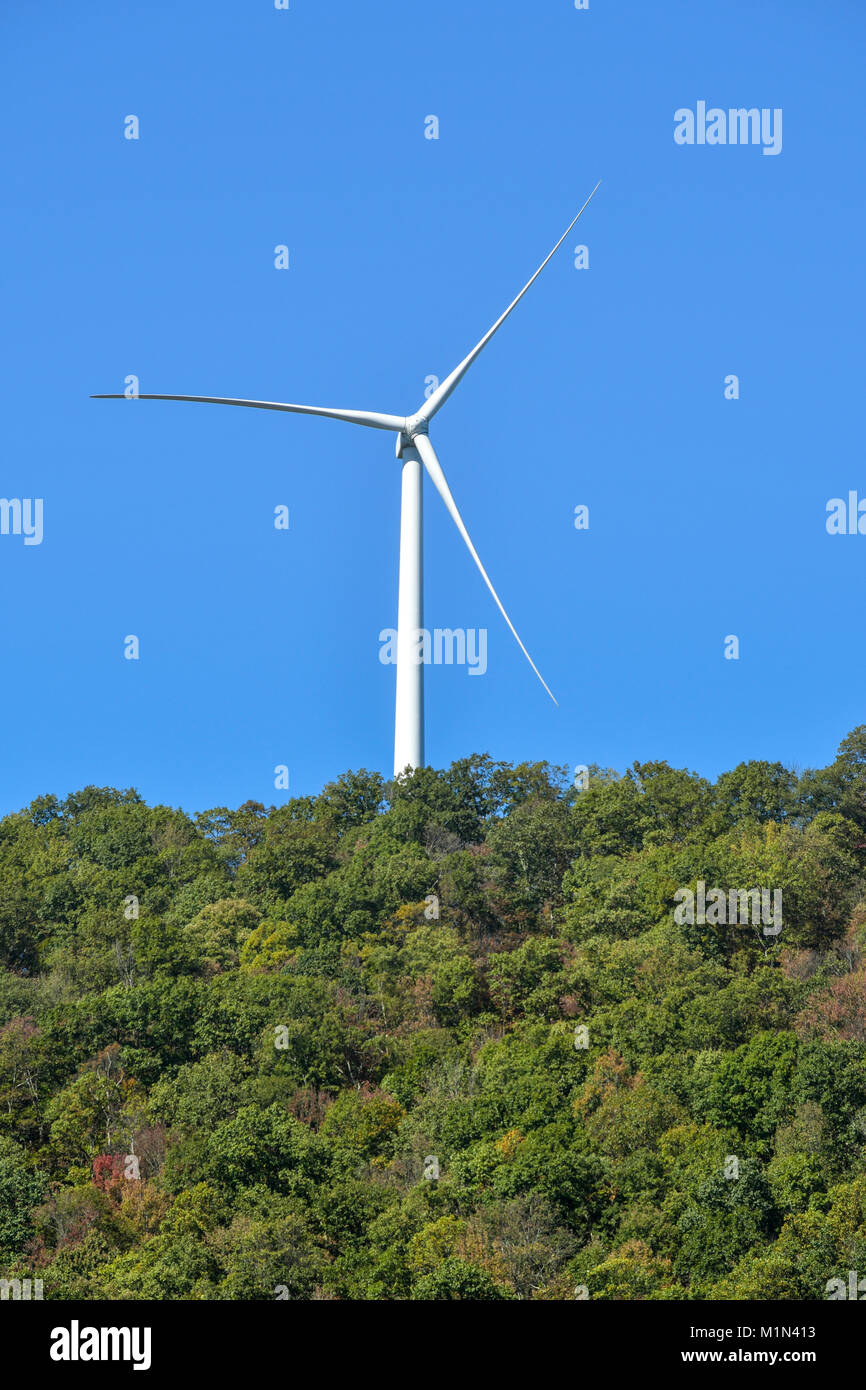 Giant wind turbine on a hill against blue sky Stock Photo - Alamy