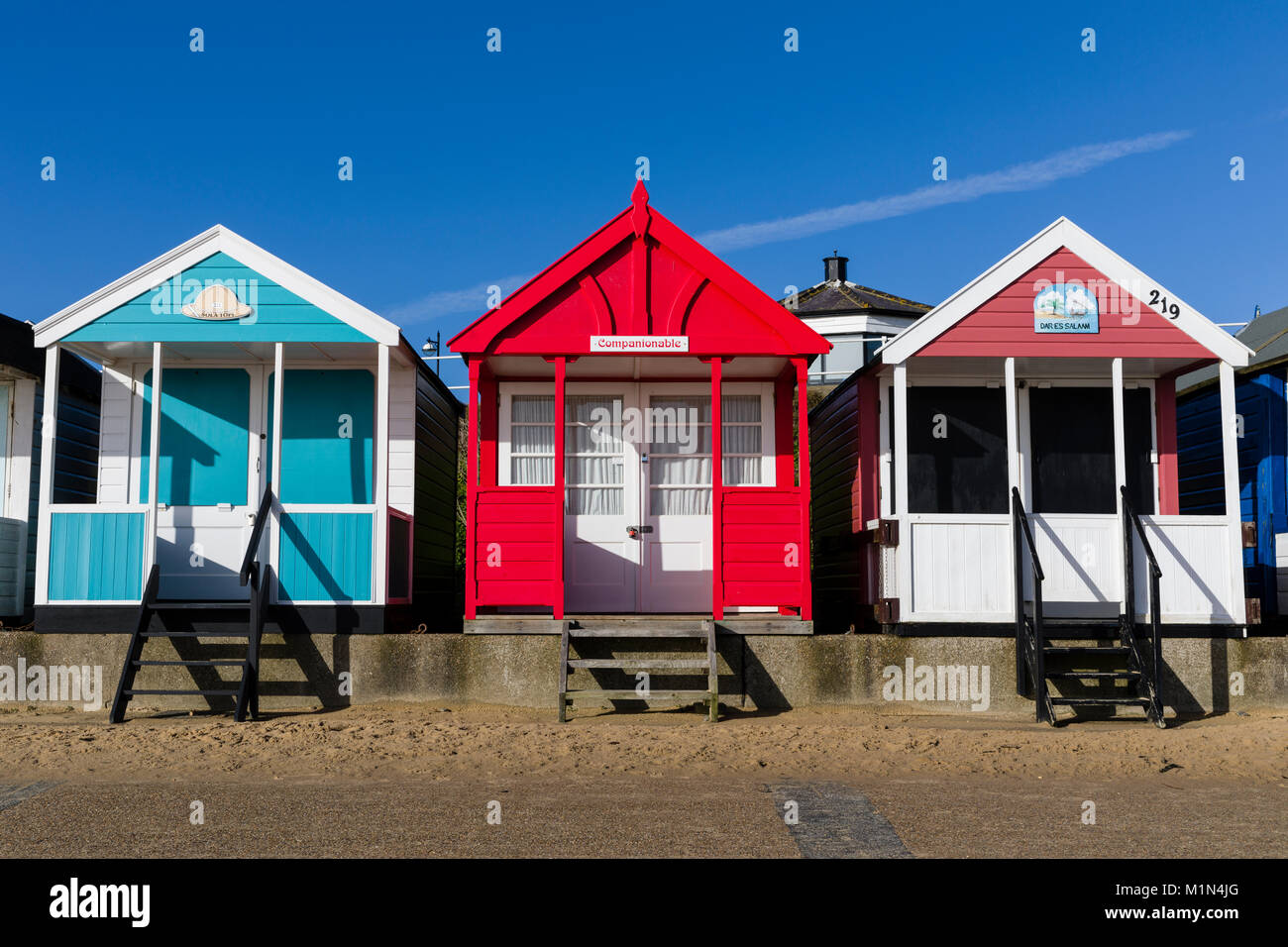 Traditional Seaside Beach Huts with a brilliant Blue Sky backdrop on ...
