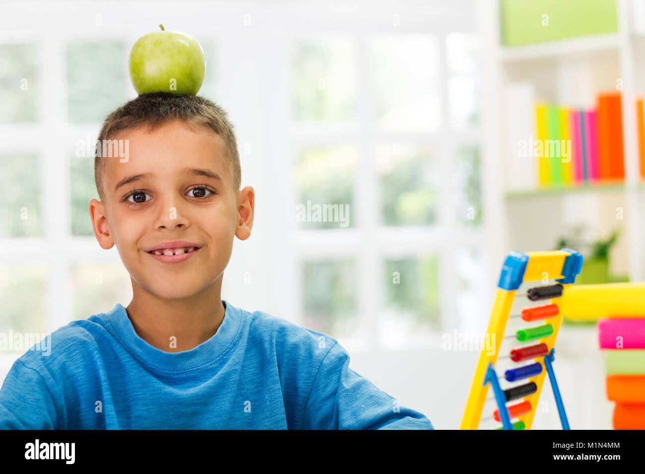 child playing with apple on worktable Stock Photo - Alamy