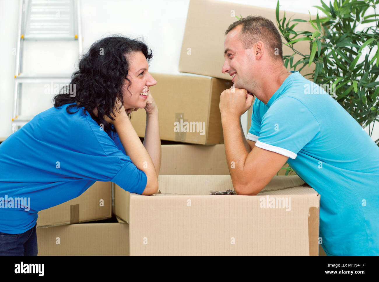 Young smiling couple moving Stock Photo - Alamy