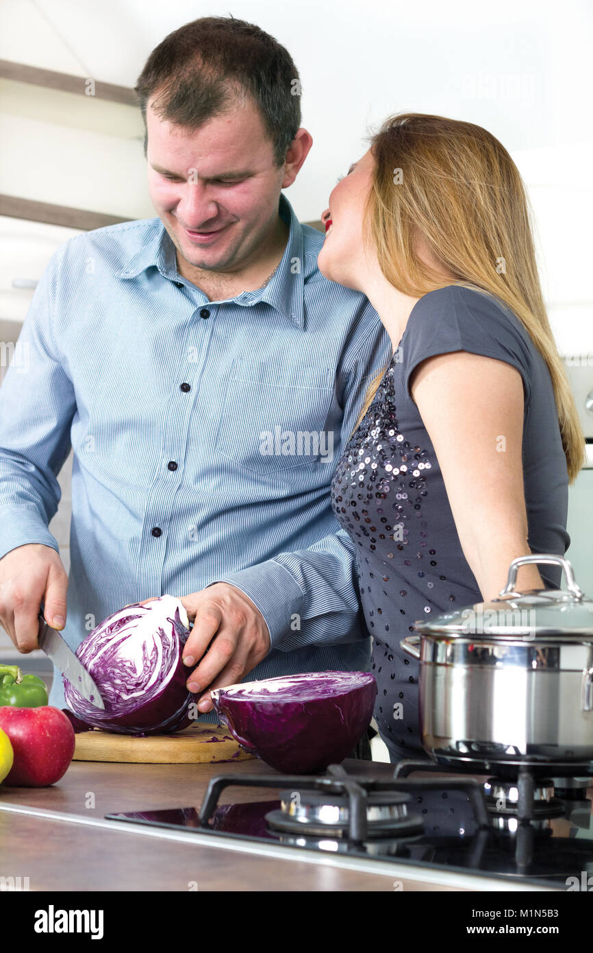 happy couple in the kitchen husband preparing meals Stock Photo - Alamy
