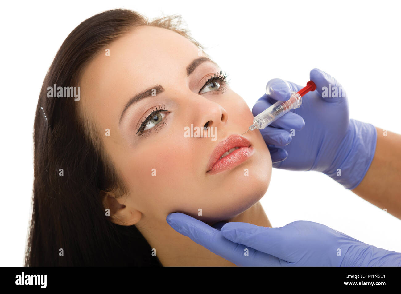 Botox shot in the female cheek,close up Stock Photo - Alamy
