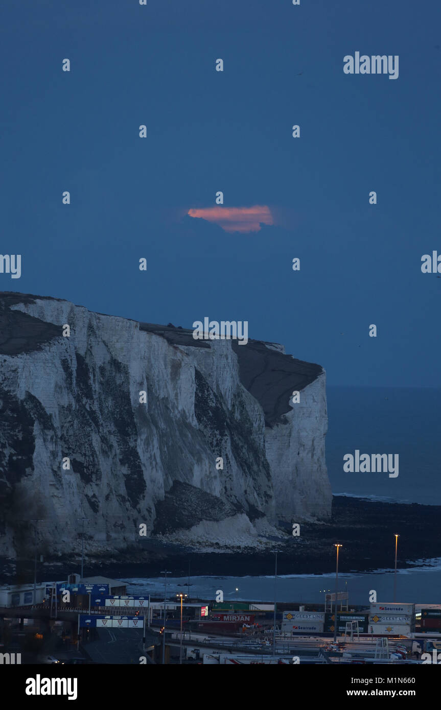 The moon is seen through clouds rises over the White Cliffs of Dover ...