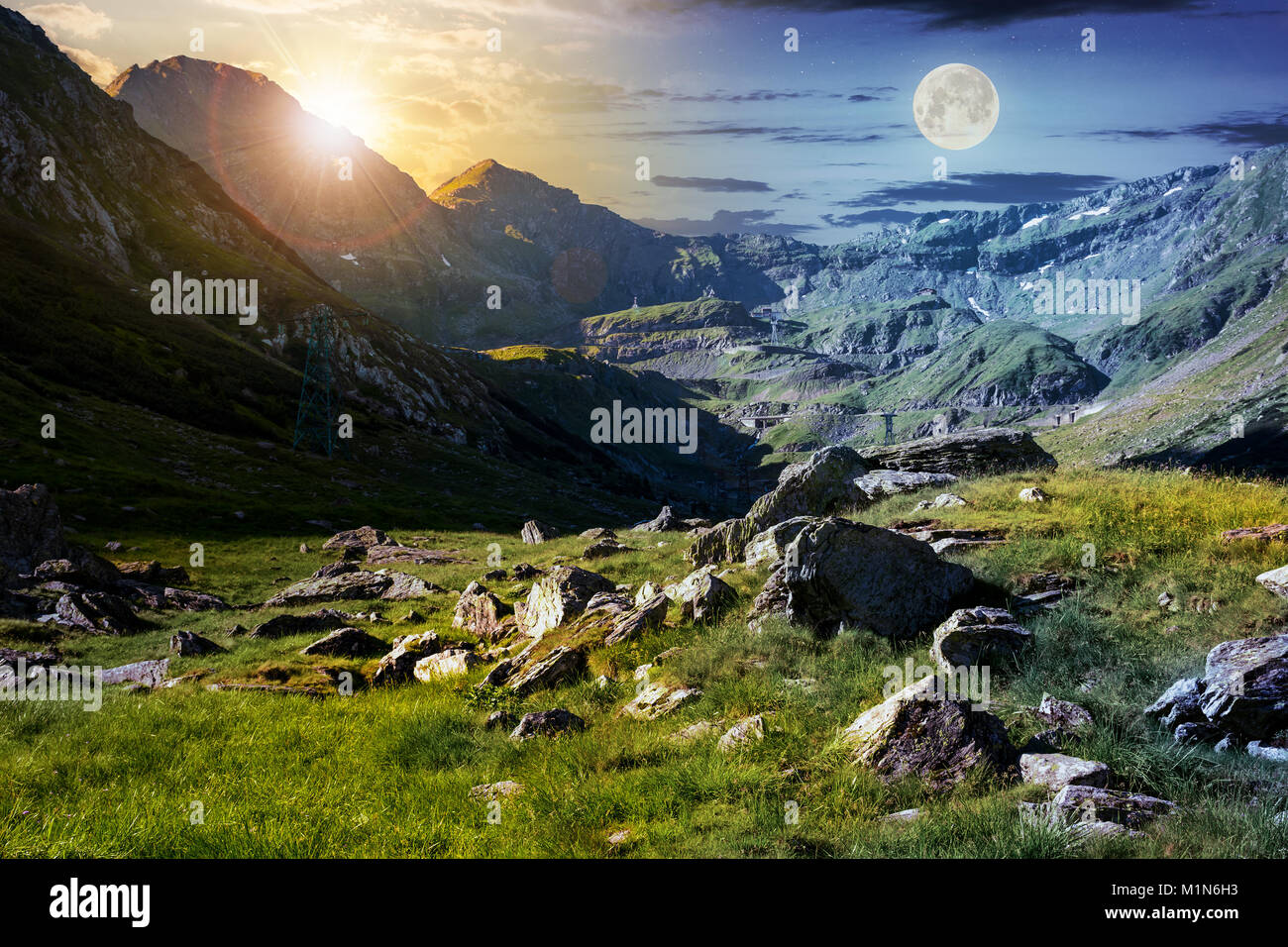 time change concept in Transfagarasan valley. rocks on grassy meadow ...