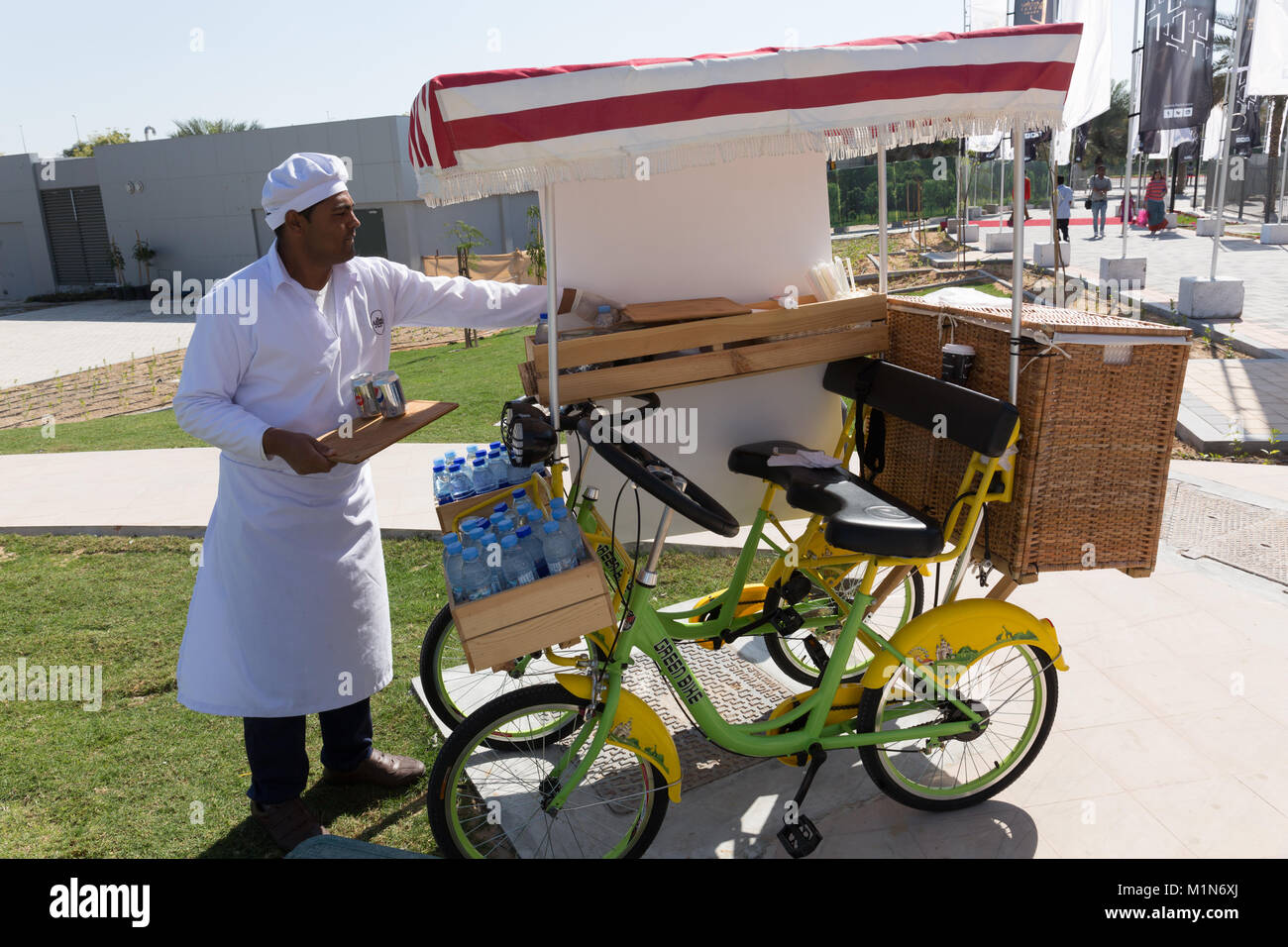 Man selling bottled water on a bicycle stall Stock Photo - Alamy
