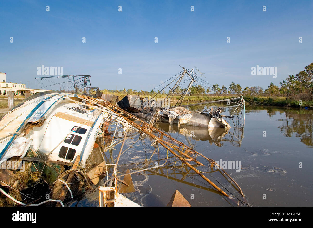 Sunken and overturned shrimp trawlers scattered through the bayou by ...