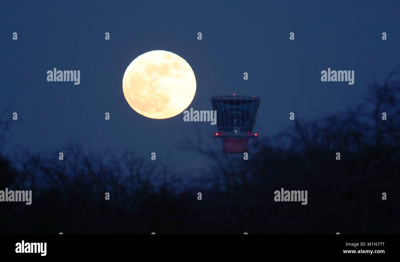 A 'blue moon' rises behind the control tower at London's Heathrow ...