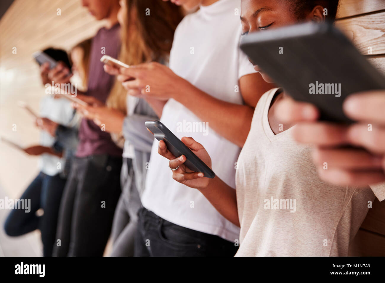 Teenage Students Using Digital Devices On College Campus Stock Photo ...