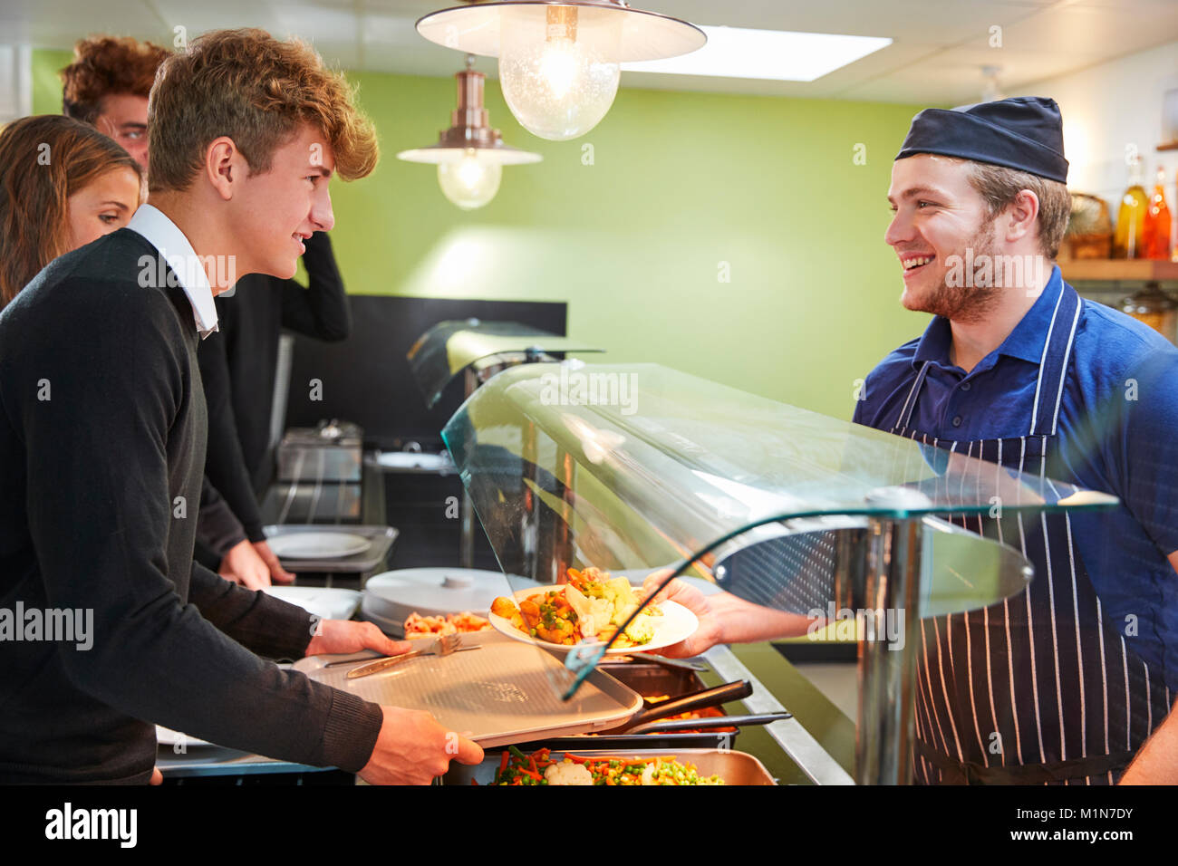 Teenage Students Being Served Meal In School Canteen Stock Photo - Alamy