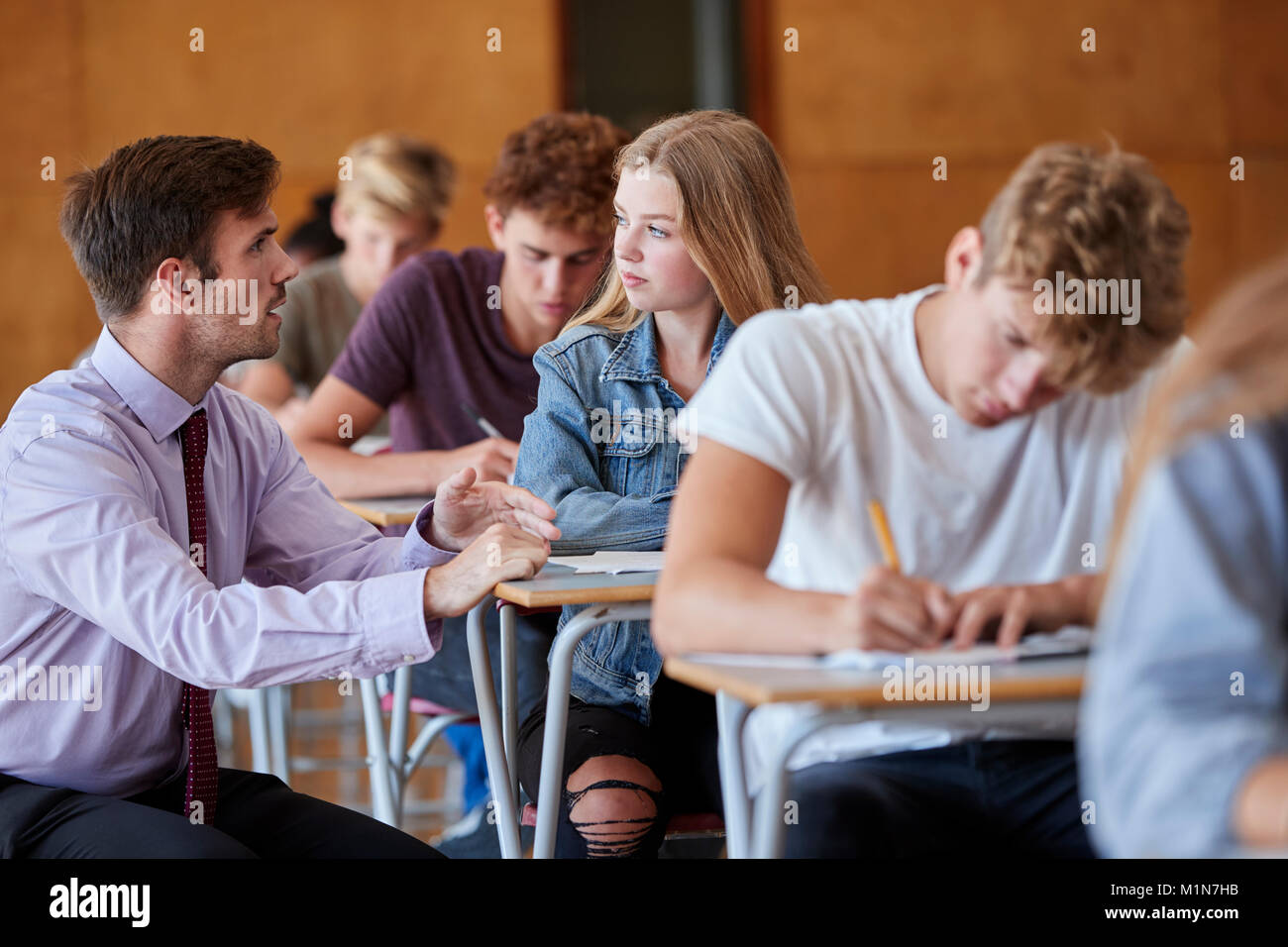 Teenage Students Sitting Examination With Teacher Invigilating Stock ...
