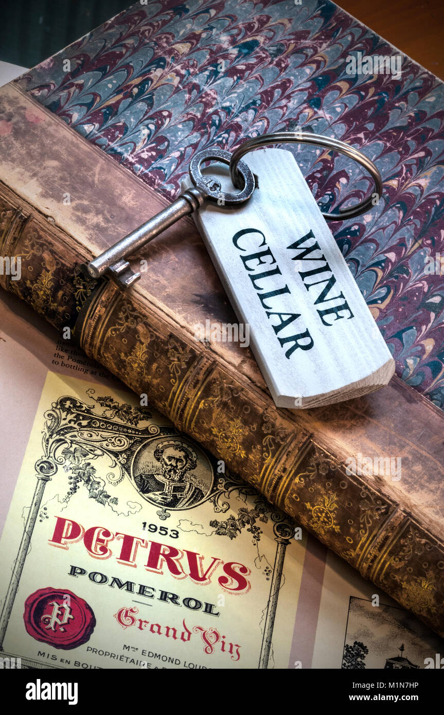 Wine cellar key on old leather bound book and illustration of Chateau ...