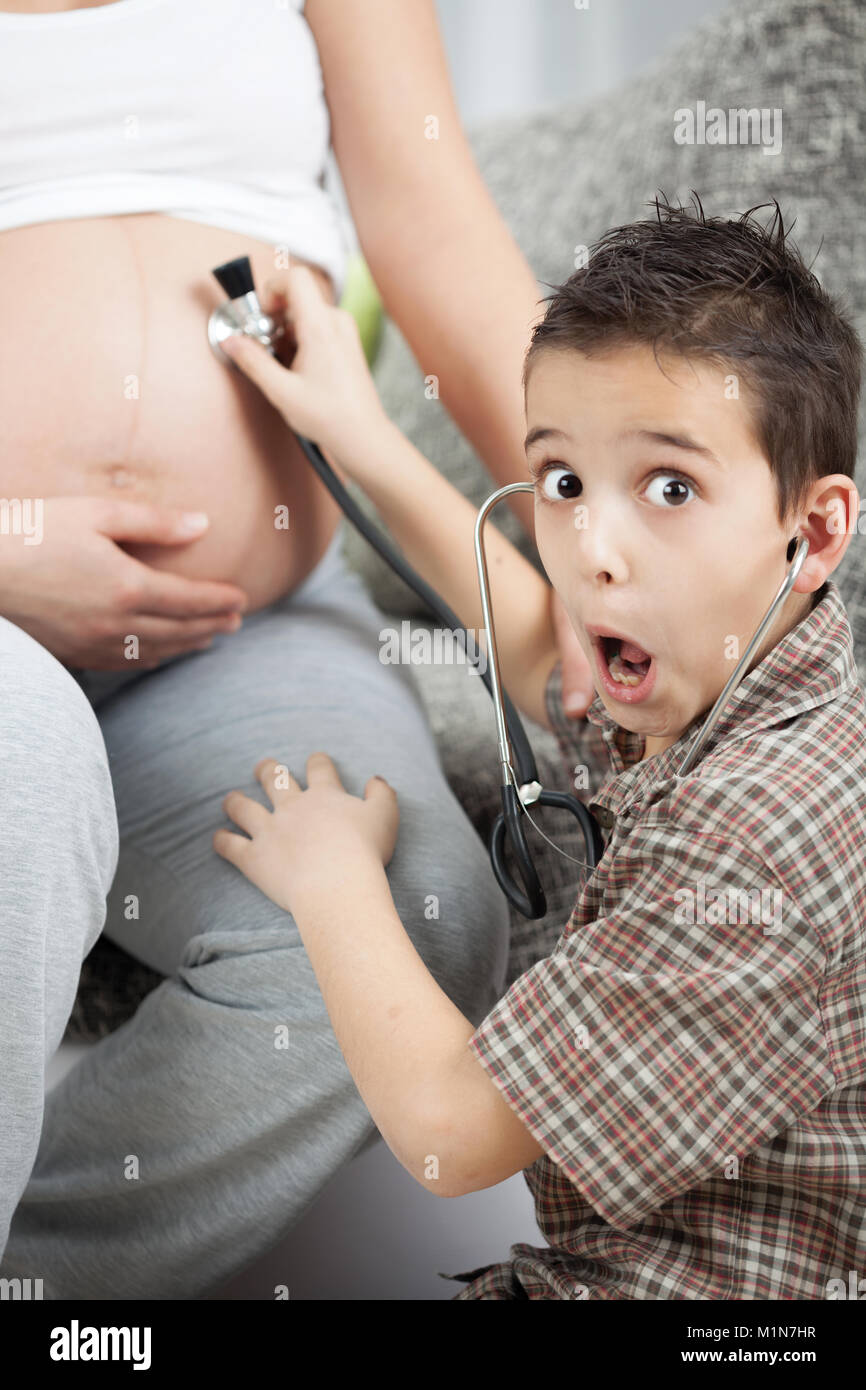 surprised little boy for the first time, hear the heartbeat of his ...