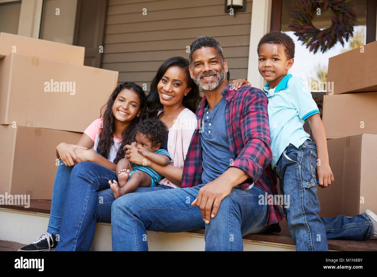 Family With Children Outside House On Moving Day Stock Photo - Alamy