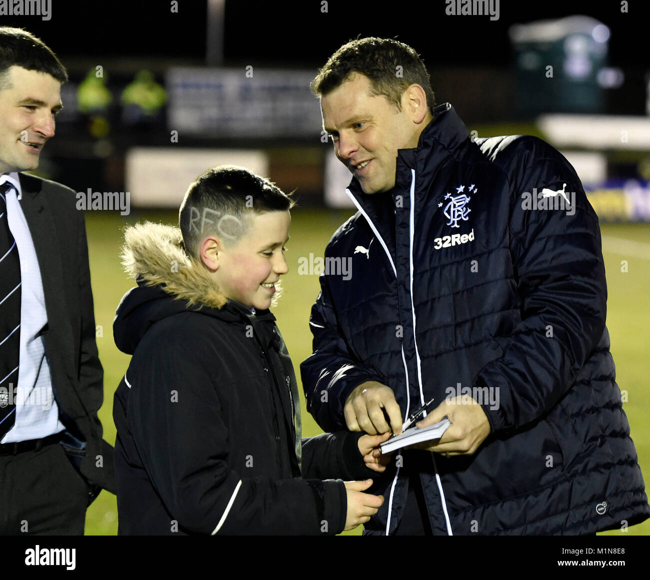 Rangers manager Graeme Murty signs an autograph for a young fan with ...
