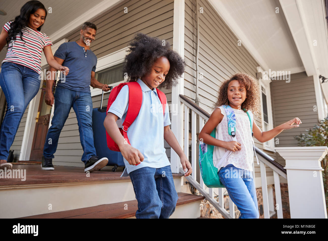Family With Luggage Leaving House For Vacation Stock Photo - Alamy