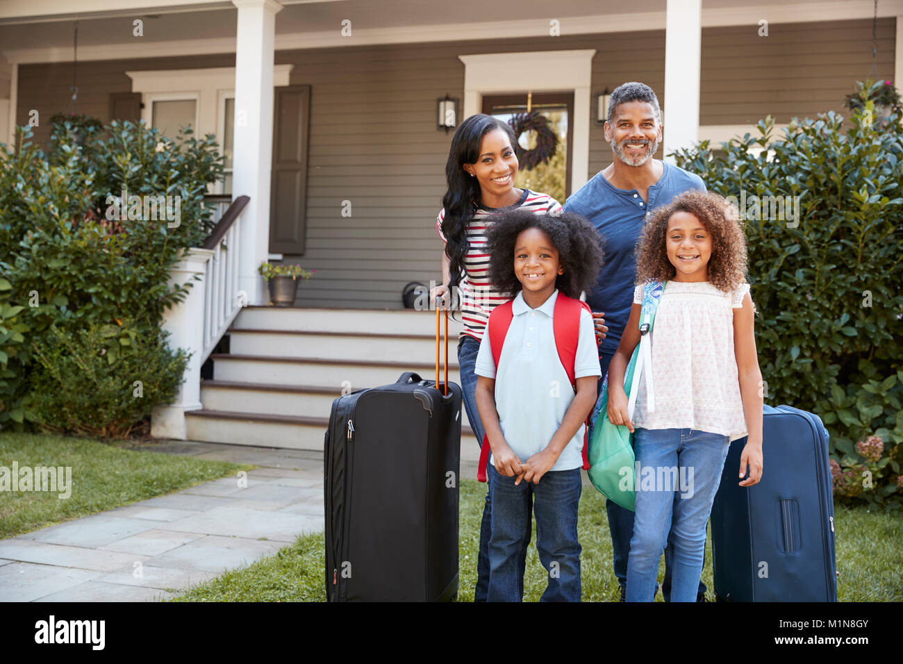 Portrait Of Family With Luggage Leaving House For Vacation Stock Photo ...