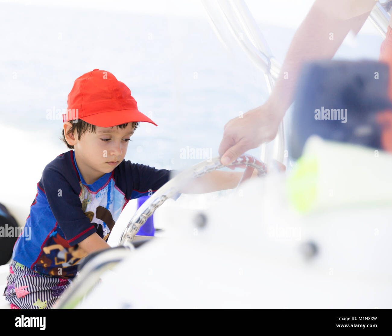 Boy driving boat hi-res stock photography and images - Alamy