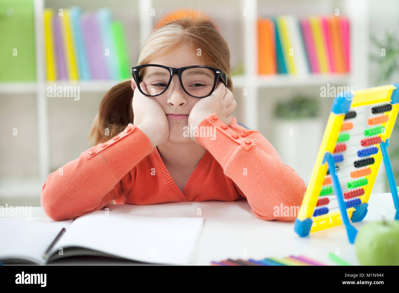 A little girl bored with her homework Stock Photo - Alamy