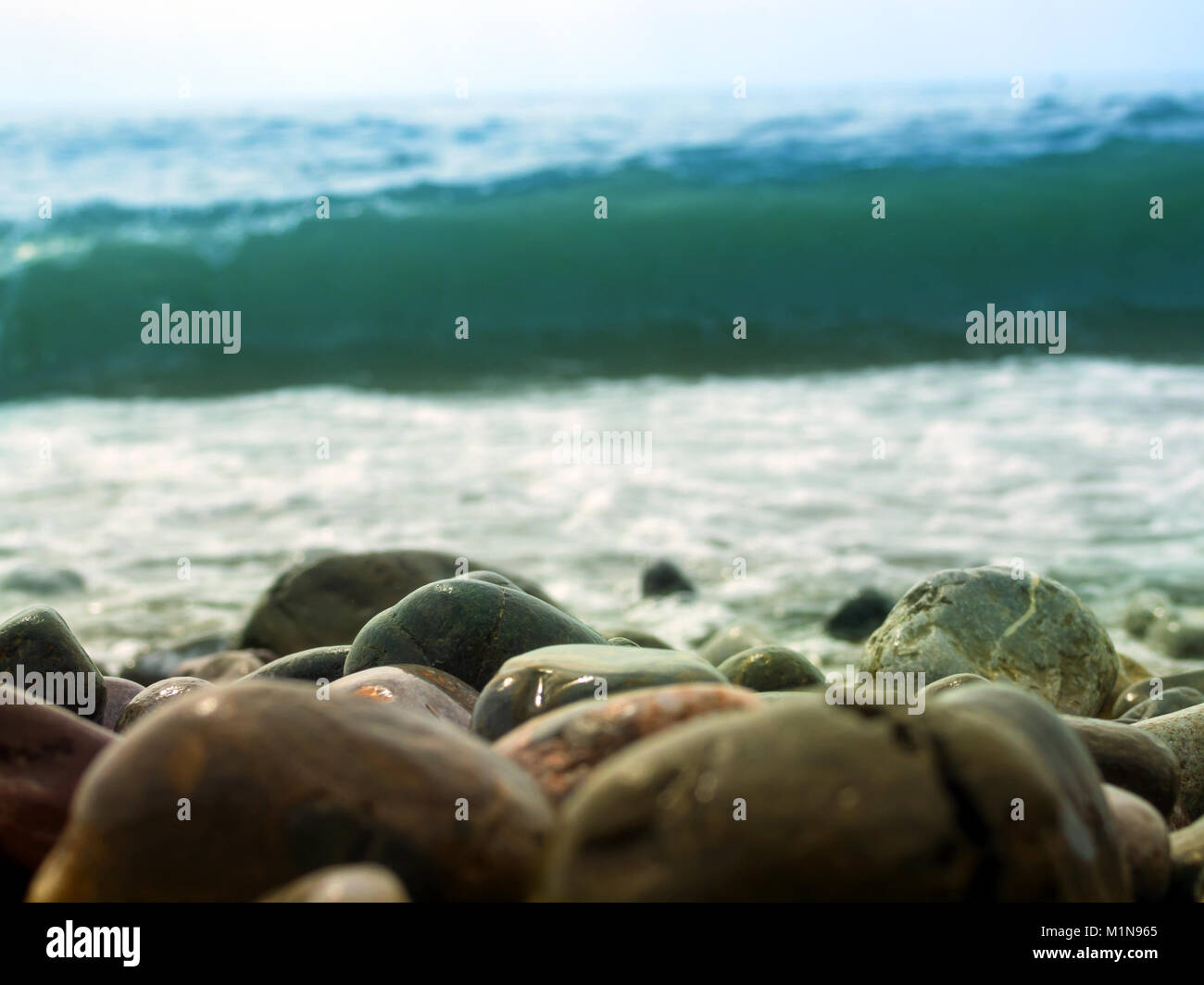 Sea wave rolled on the pebble beach Stock Photo - Alamy