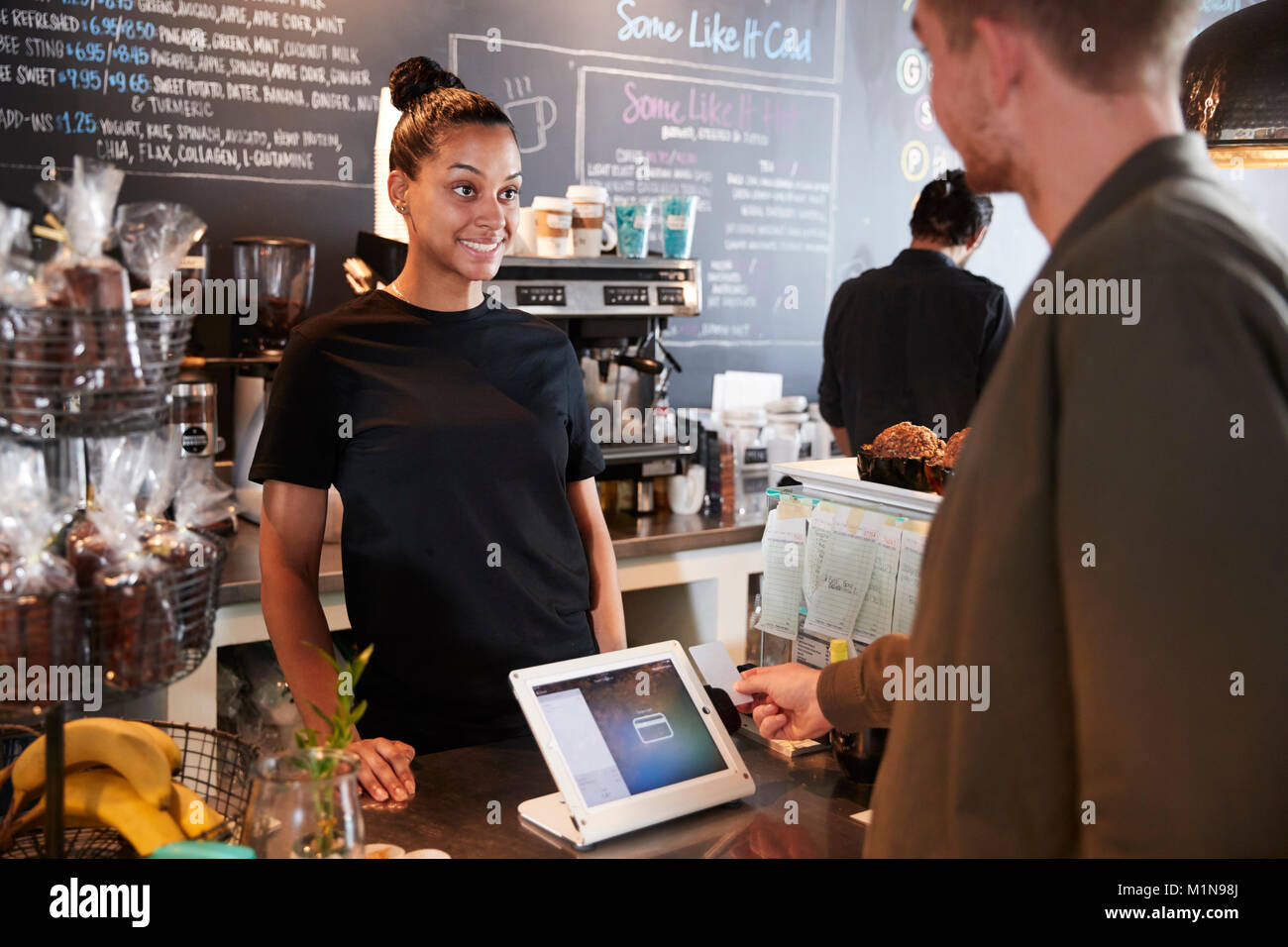 Customer Paying In Coffee Shop Using Credit Card Stock Photo - Alamy