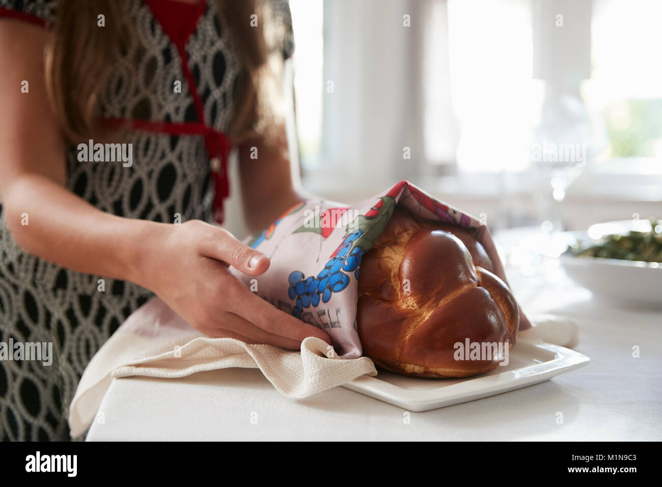 Girl covering challah bread for Shabbat meal, close up Stock Photo - Alamy