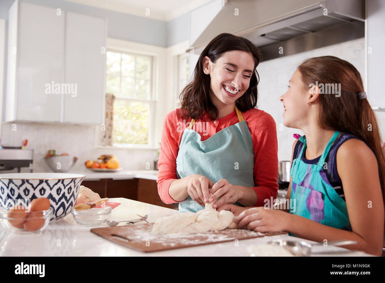 Jewish mother and daughter plaiting dough for challah bread Stock Photo ...