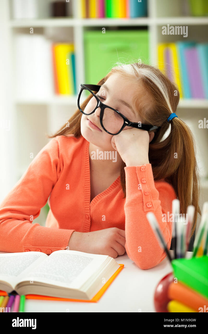 A little red-haired girl bored with her homework Stock Photo - Alamy