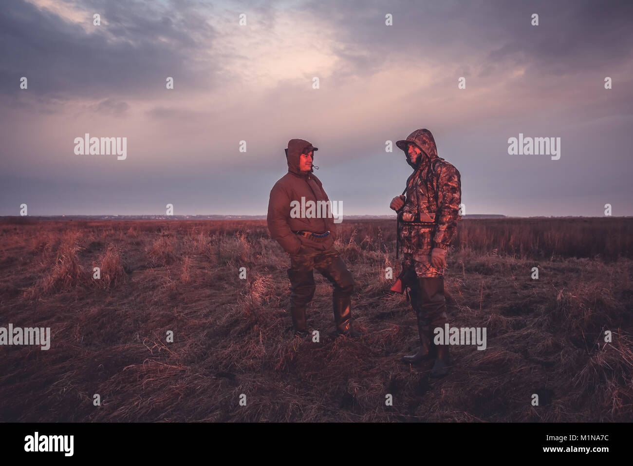 Hunters during hunting spring season in rural field at sunrise Stock ...