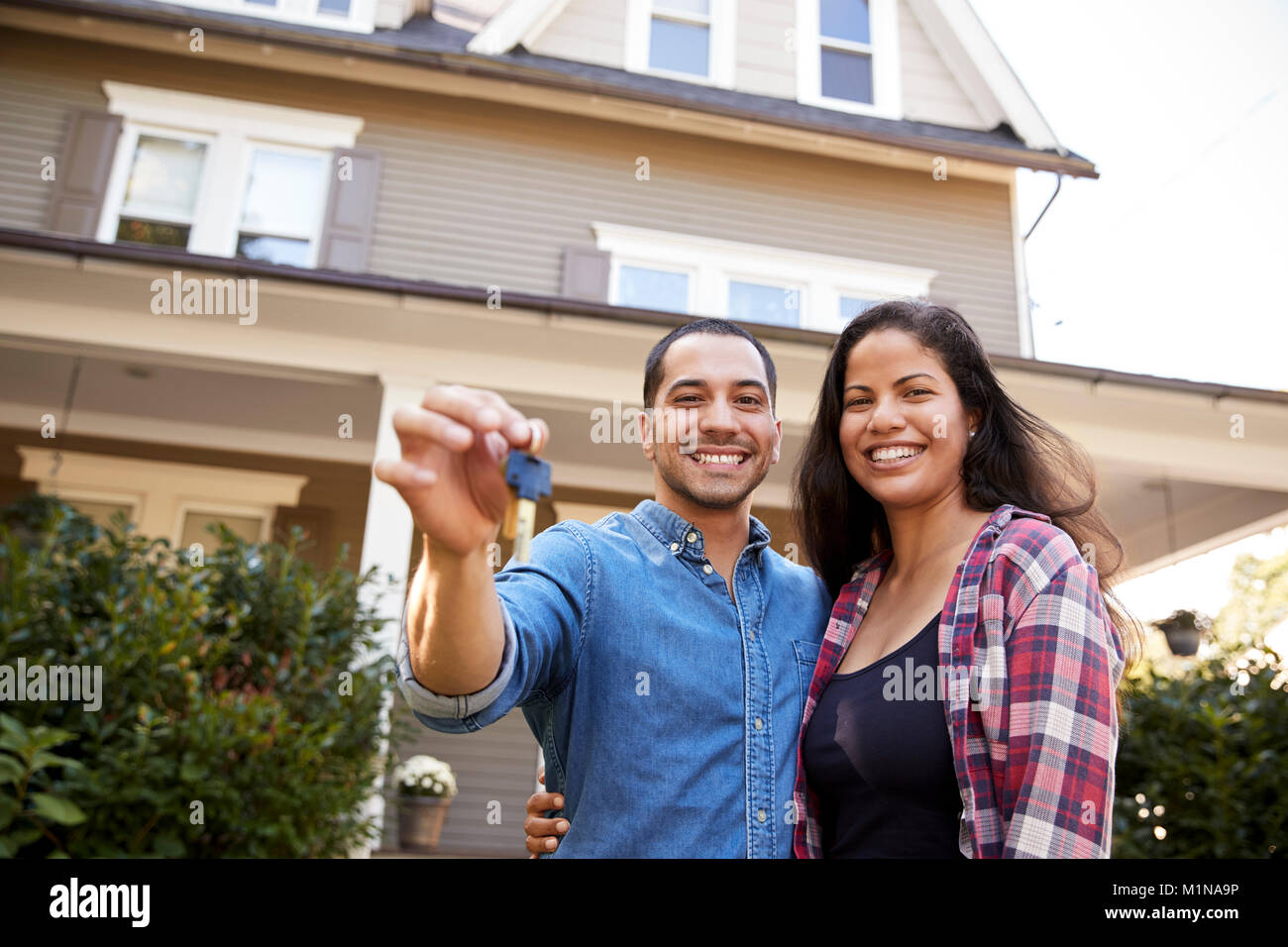 Portrait Of Couple Holding Keys To New Home On Moving In Day Stock ...