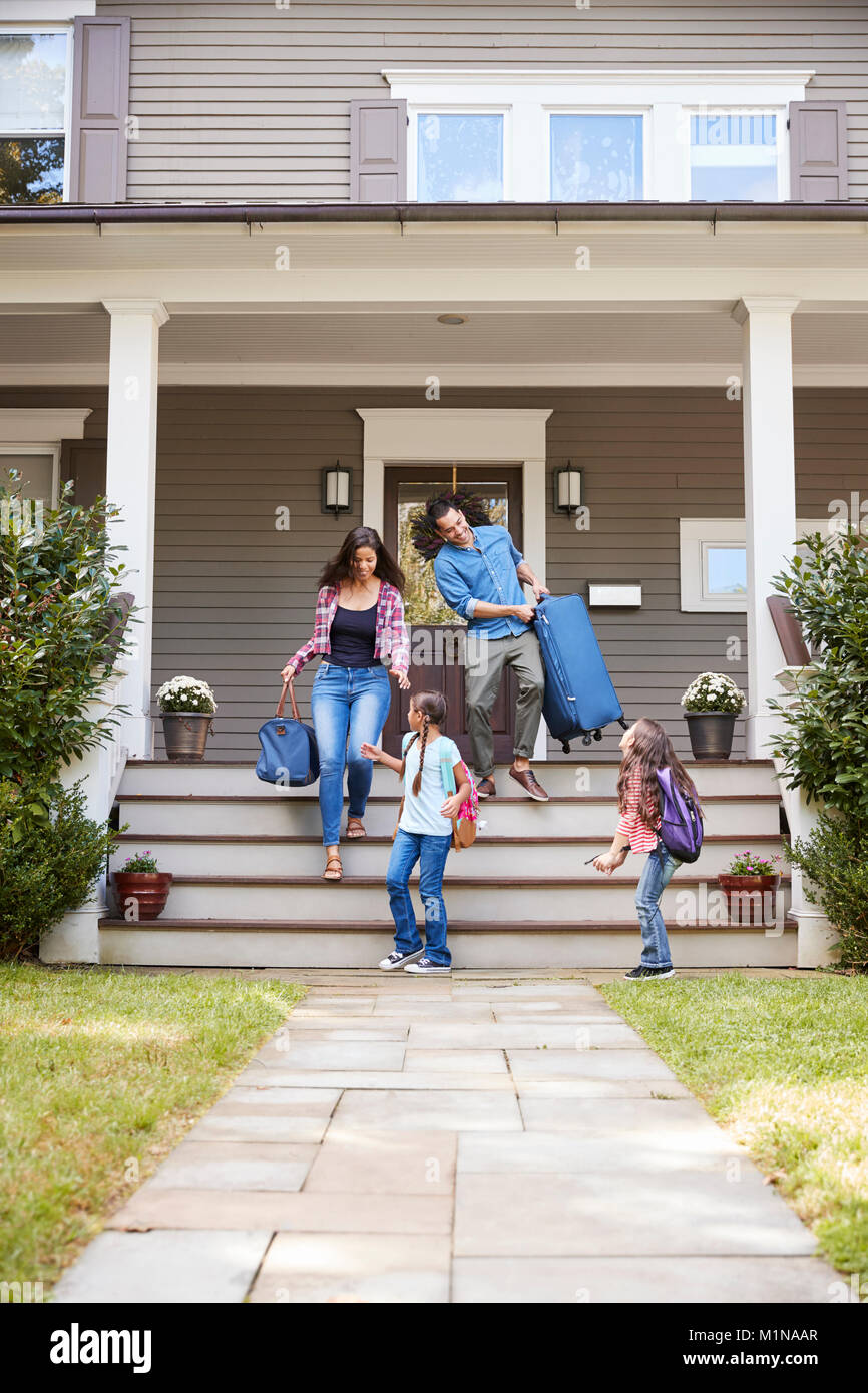 Family With Luggage Leaving House For Vacation Stock Photo - Alamy
