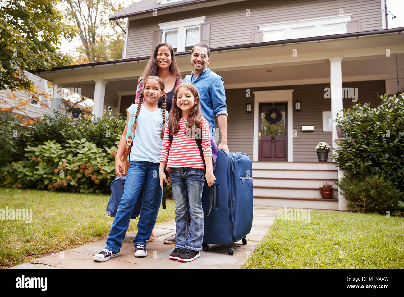 Portrait Of Family With Luggage Leaving House For Vacation Stock Photo ...