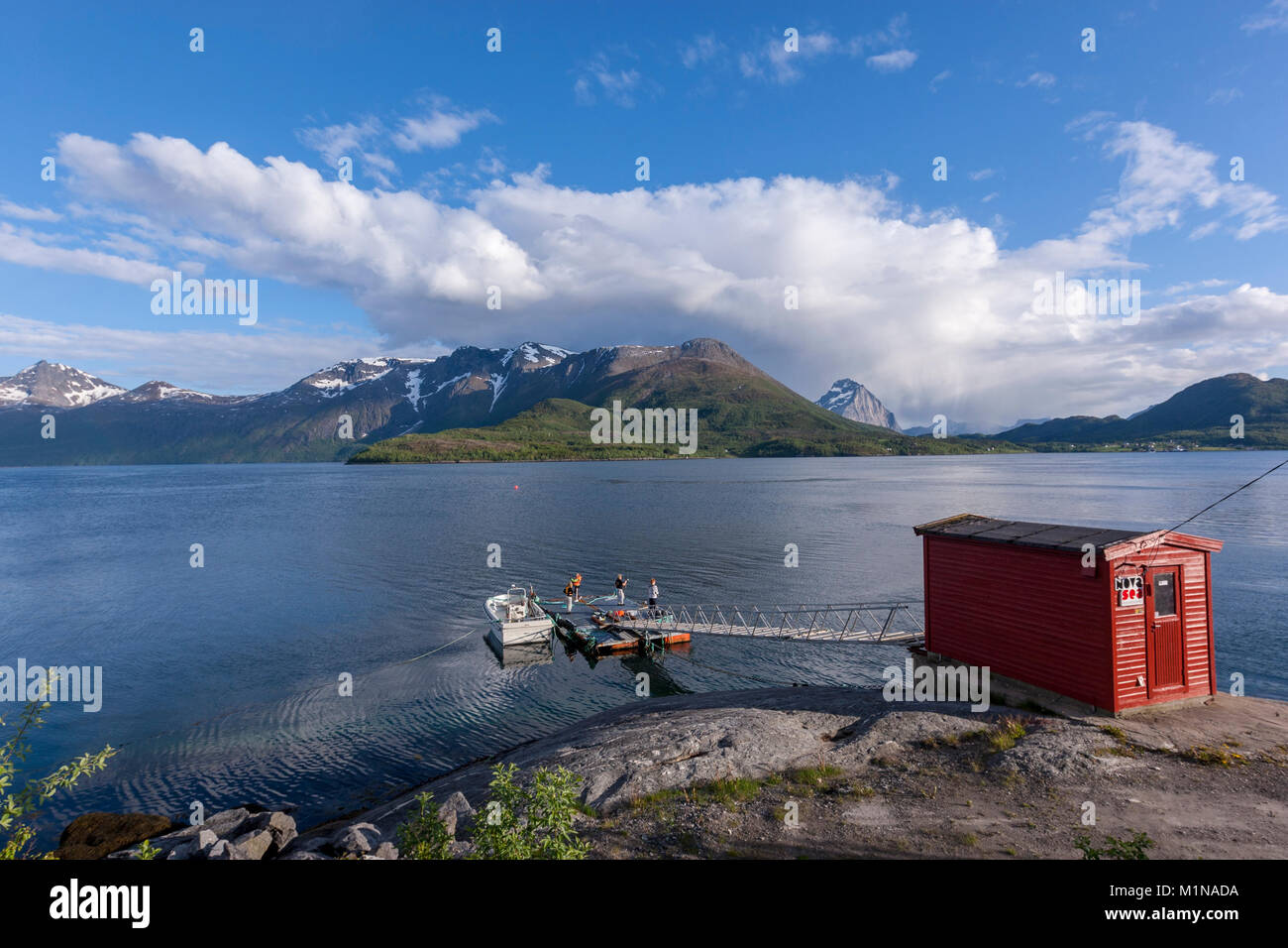 Four persons fishing along Norwegian County Road 17 from Bodo to Halsa ...