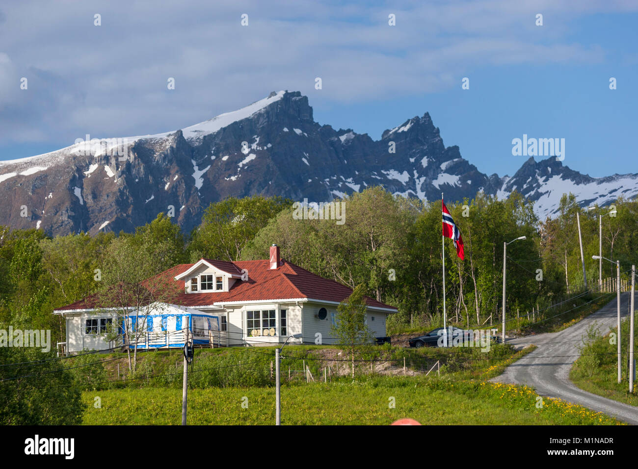 Scandinavian wooden house with norwegian flag along Norwegian County ...