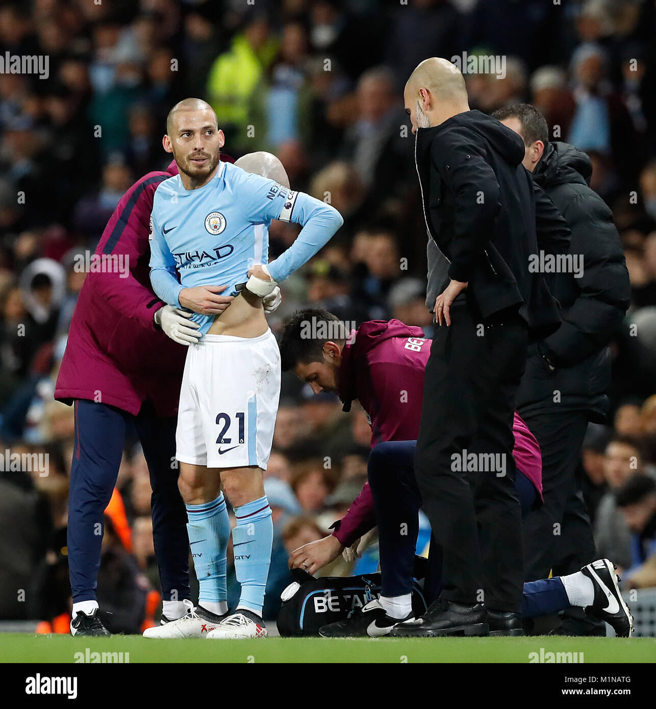 Manchester City's David Silva receives treatment for an injury during ...