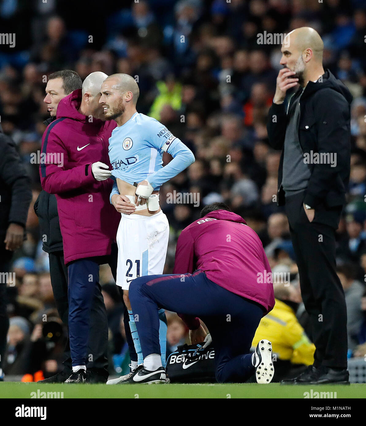 Manchester City's David Silva receives treatment for an injury during ...