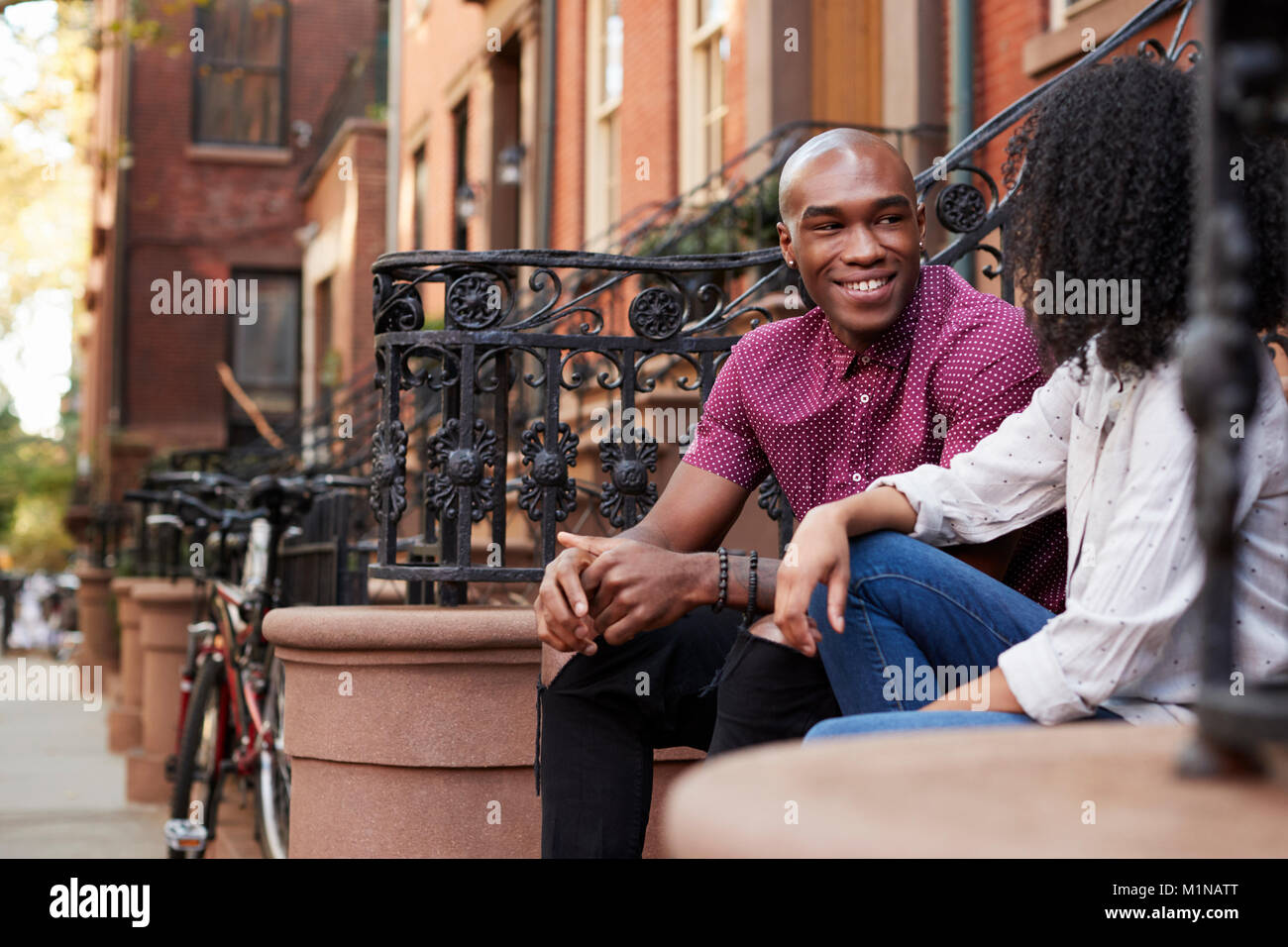 Man woman sitting on stoop hi-res stock photography and images - Alamy