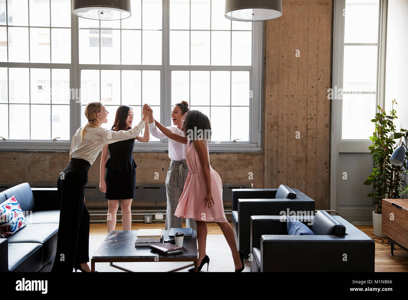 Female colleagues high five at a motivational meeting Stock Photo - Alamy