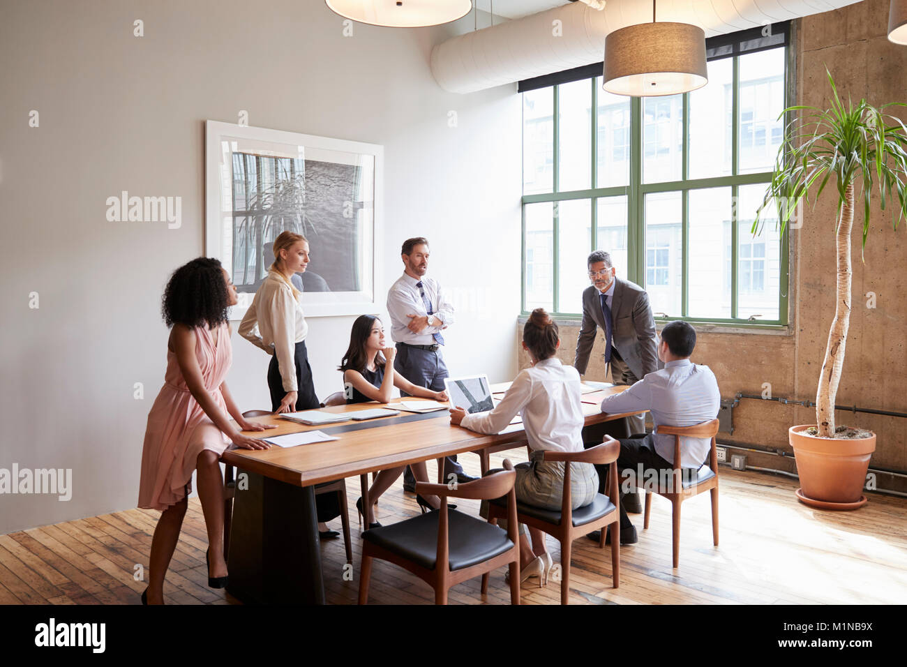 Young professionals around a table at a business meeting Stock Photo ...