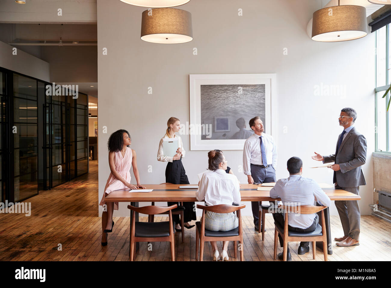 Young professionals around a table at a business meeting Stock Photo ...